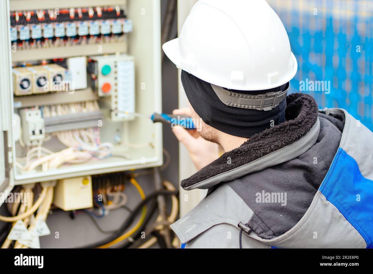 Instrumentation and automation engineer in white hard hat checks ...