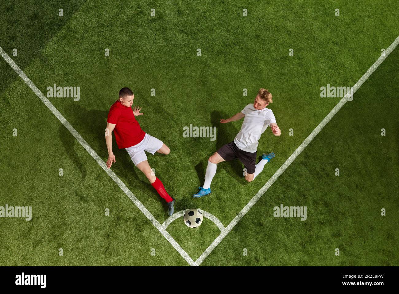 Soccer football players wearing sportswear, uniform hitting the ball ...