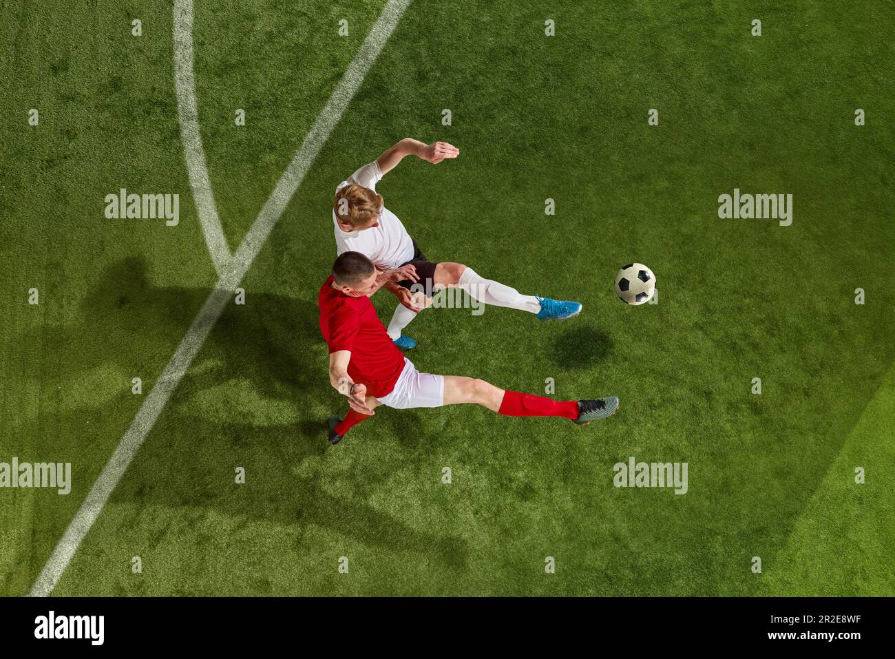 Dynamic shot with professional soccer players wearing uniform playing ...