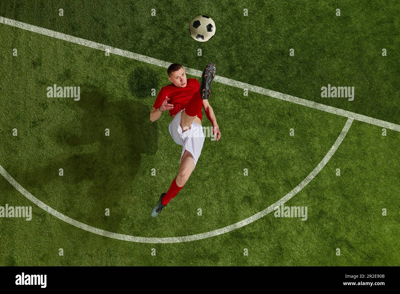 One professional football soccer player in uniform kicking the ball ...
