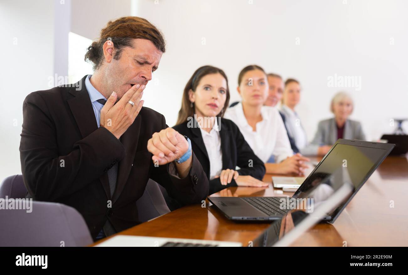 Middle aged white business man yawning at boring meeting Stock Photo ...