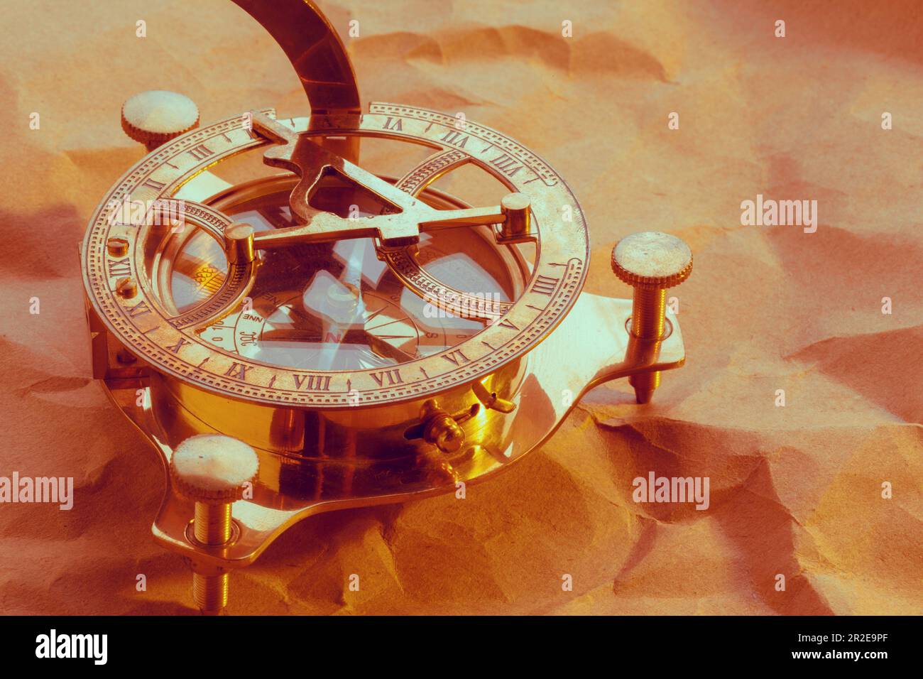 antique compass on vintage paper background Stock Photo - Alamy