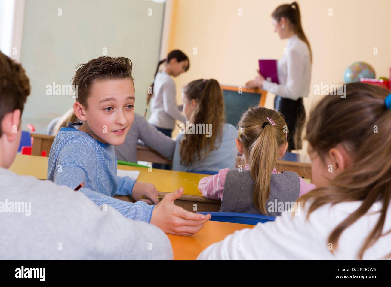 Elementary students chatting during class hi-res stock photography and ...