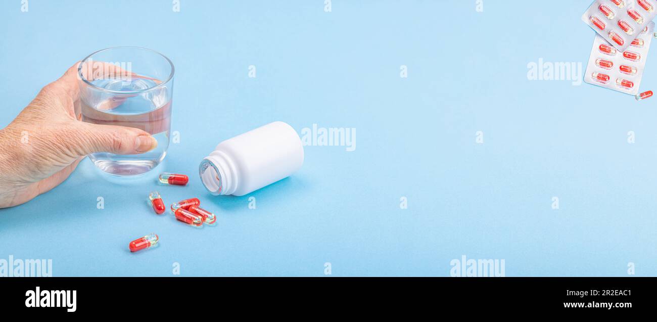 A woman takes medicine. Female hands hold capsules or pills. Treatment ...