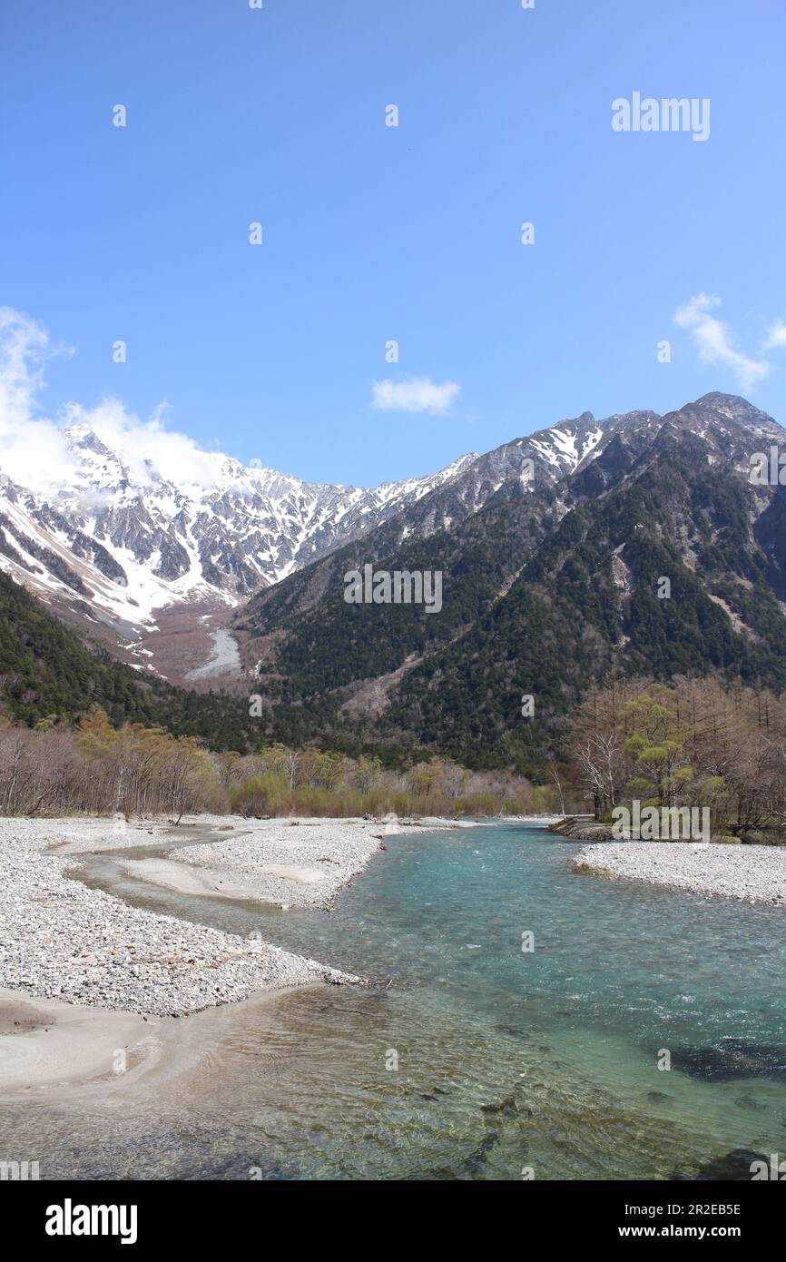 The clear Azusa River and snow-capped Mount Hotaka viewed from ...