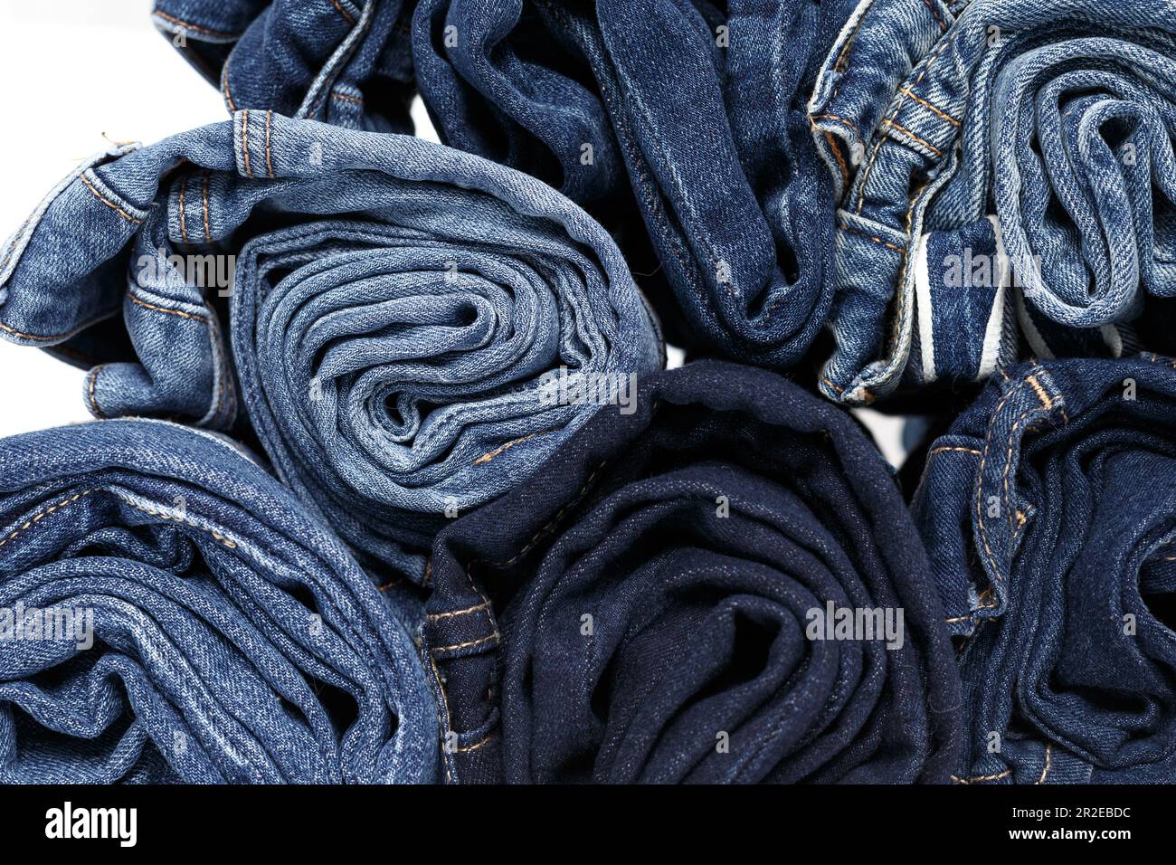 torn jeans stack background blue denim fashion beauty Stock Photo - Alamy