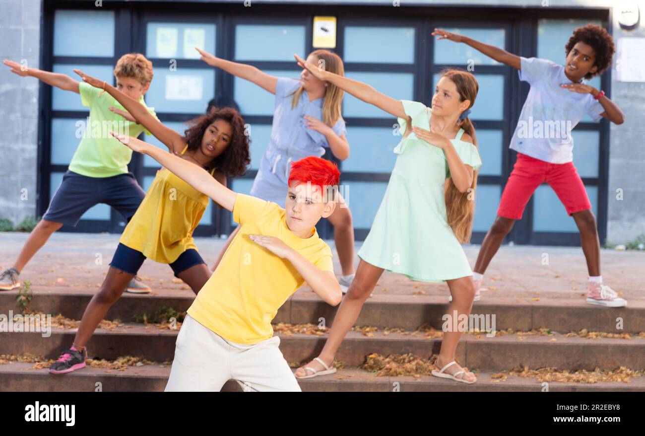 Tween boy dancing with group on summer city street Stock Photo - Alamy