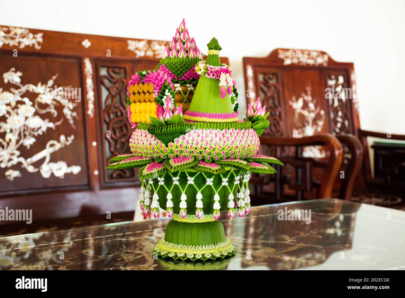 Ceremony rice offering on banana leaf flower tray at marquetry table or ...