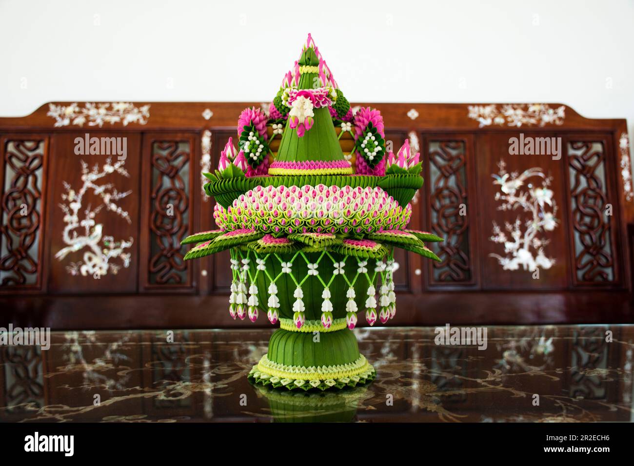 Ceremony rice offering on banana leaf flower tray at marquetry table or ...