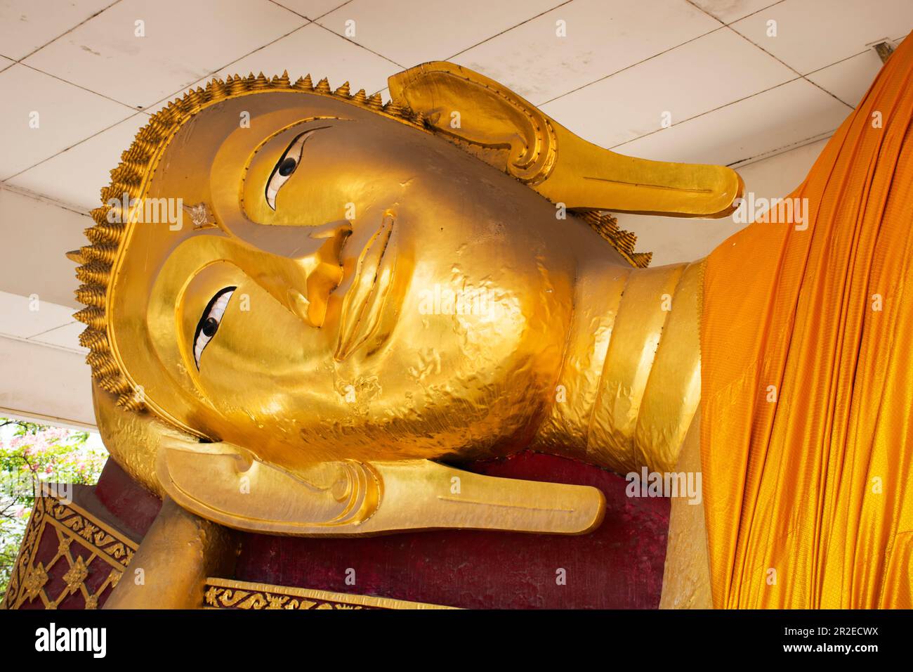 Buddha reclining attitude statue of Wat Ku or Phra Nang Rua Lom temple ...