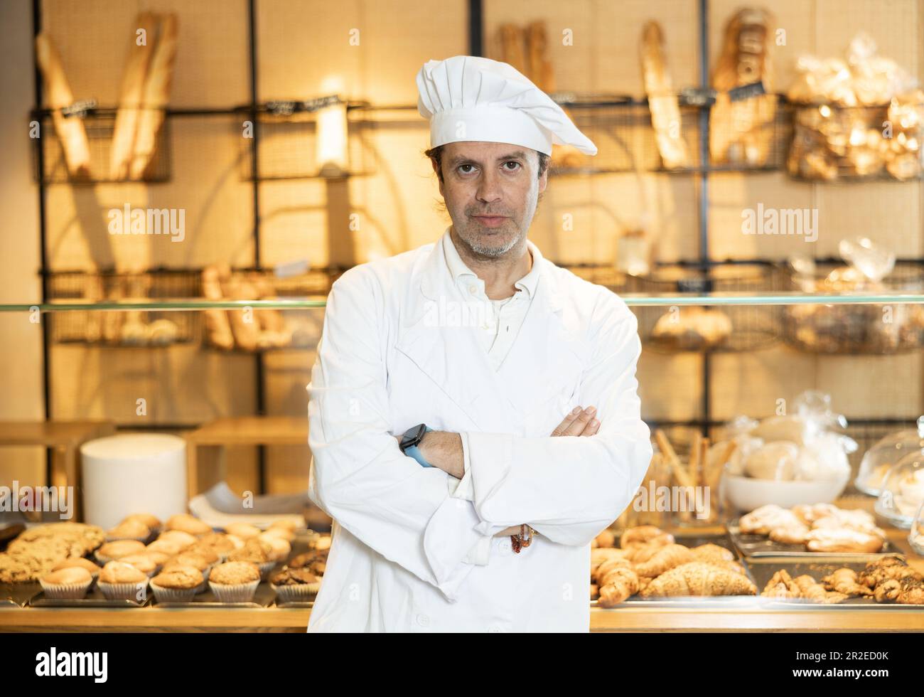 Confident male baker welcoming everyone into his bakery Stock Photo - Alamy