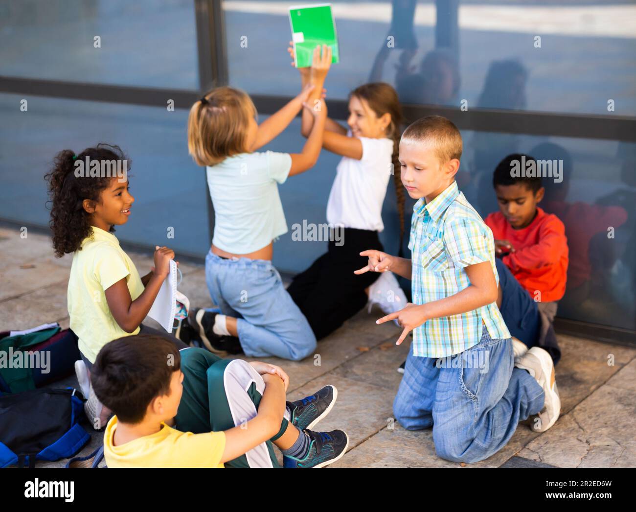 Group of children playing near school Stock Photo - Alamy