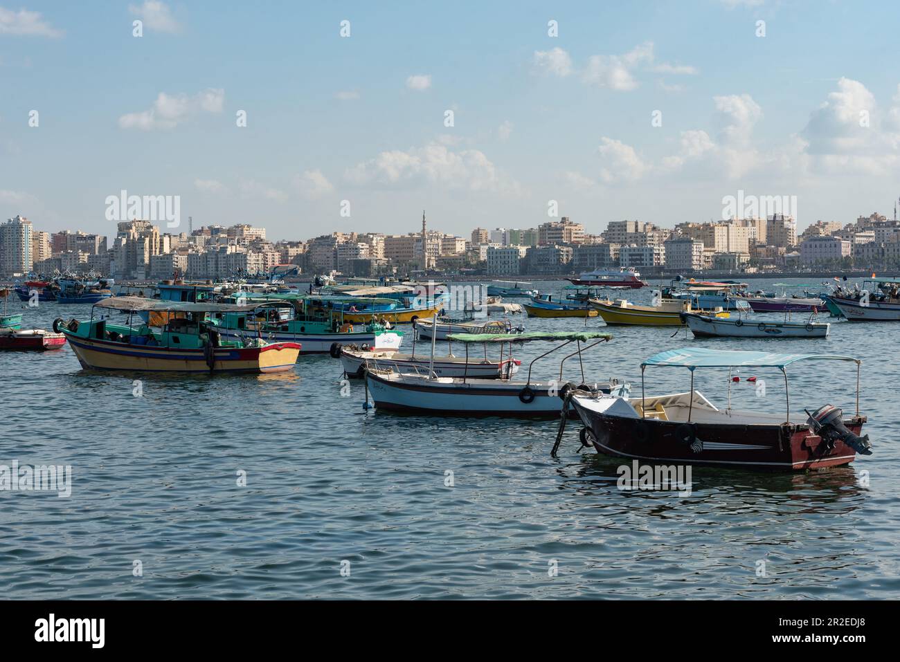 Local fishermen and fishing boats moored in the Mediterranean harbour ...