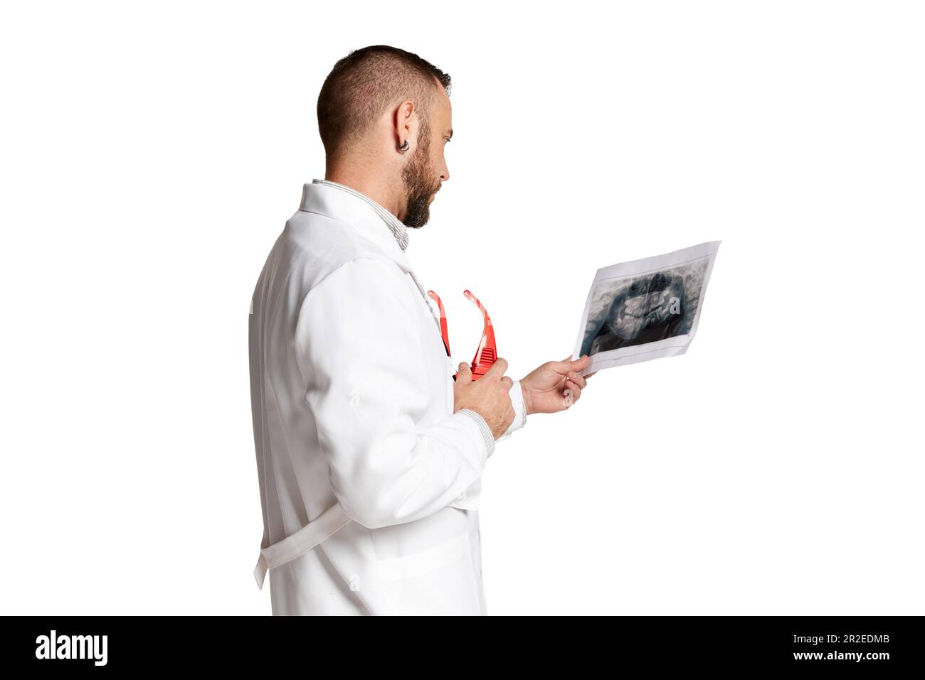 Bearded man, doctor in white med gown looking at x-ray scan checking ...