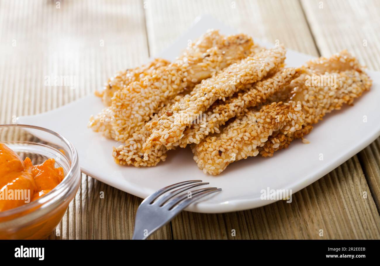 Chicken fingers in sesame with sauce Stock Photo - Alamy