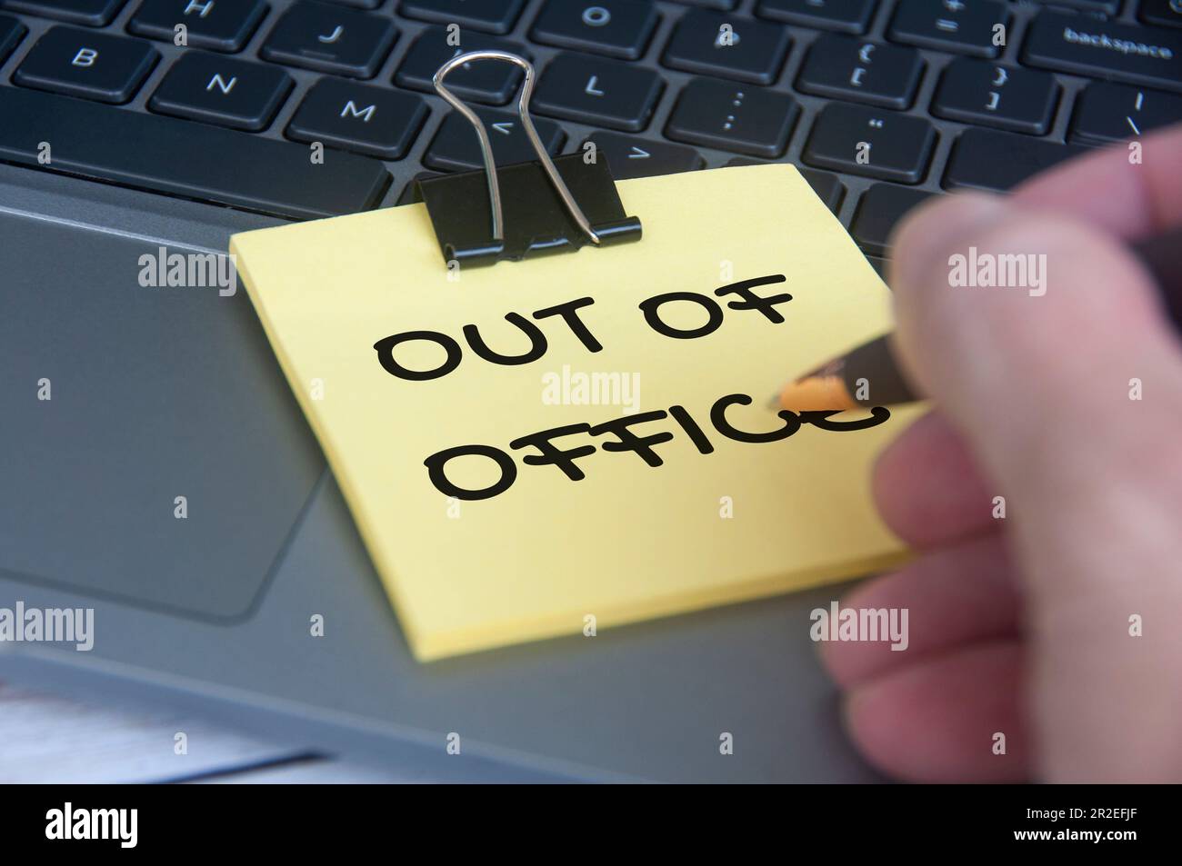 Out of office notification text sticky notes with laptop background ...