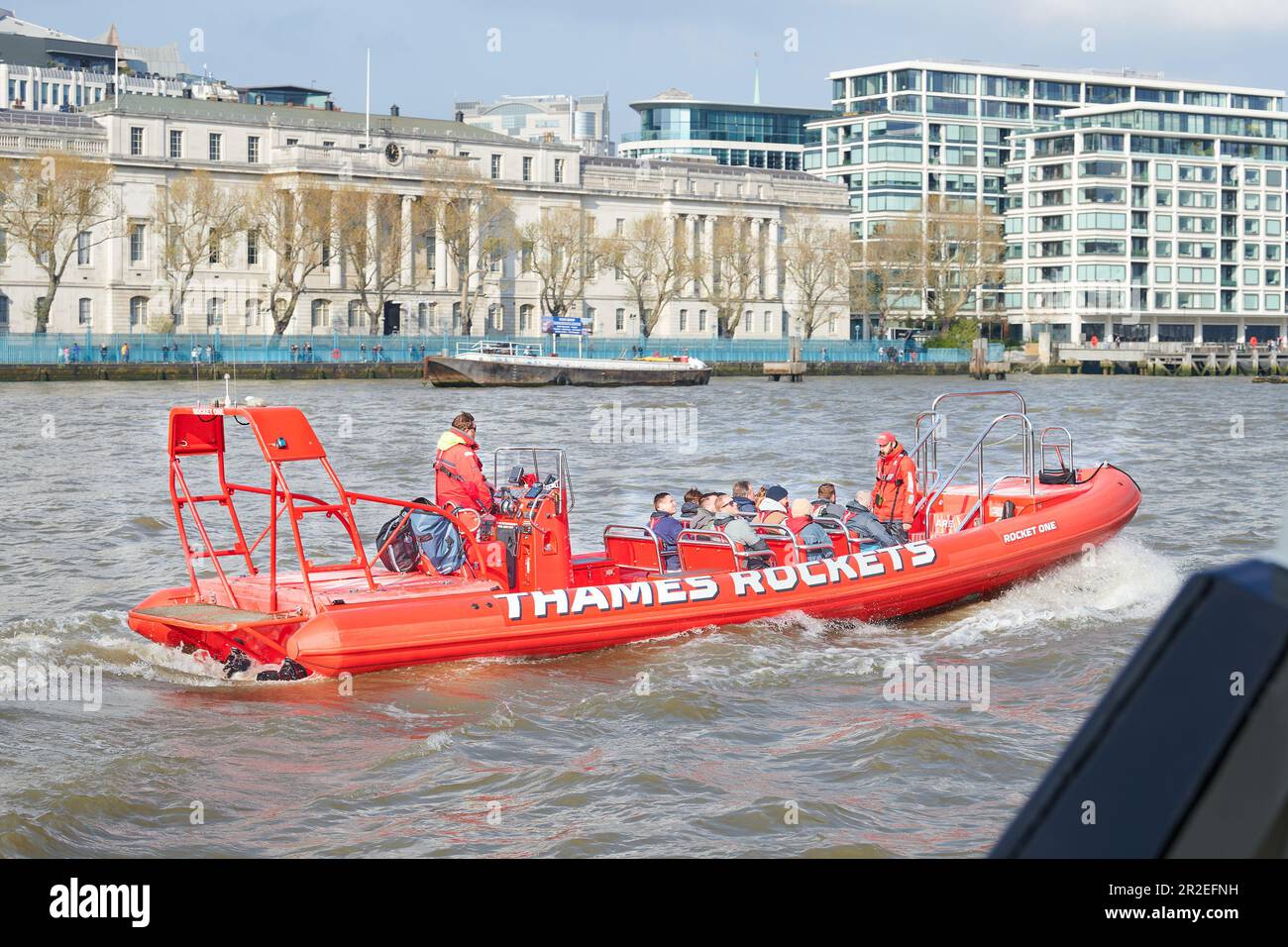 A Thames Rocket speed boat passes the Custom House on the banks of the ...