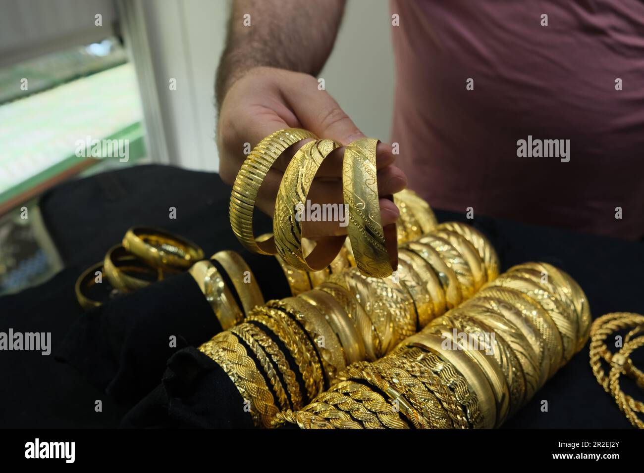 Salesman shows three golden bracelets, shopping in Turkey concept photo ...