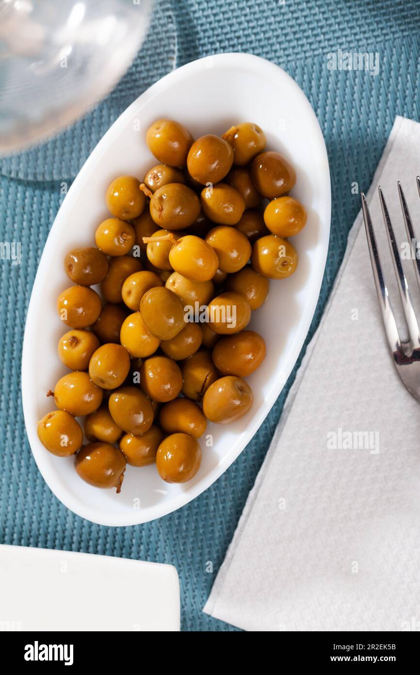 Pickled olives with a stone - a typical Spanish tapas Stock Photo - Alamy