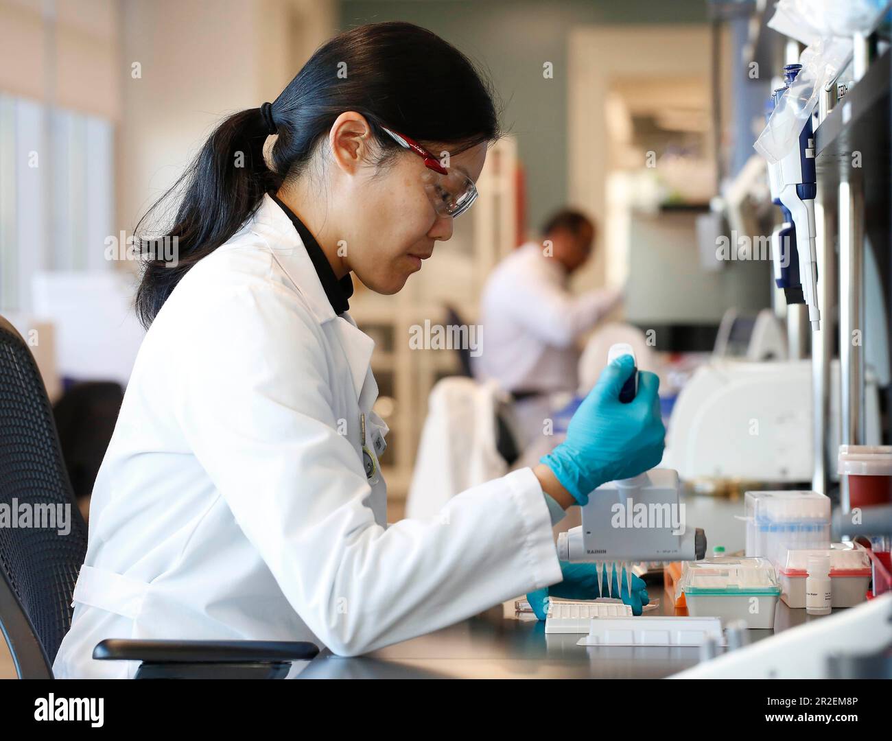 Daphne Ma, research scientist in the microbiology group, performs an enzyme-linked immunosorbent ...