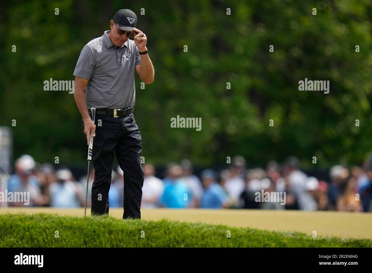 Phil Mickelson waves after his putt on the second hole during the ...