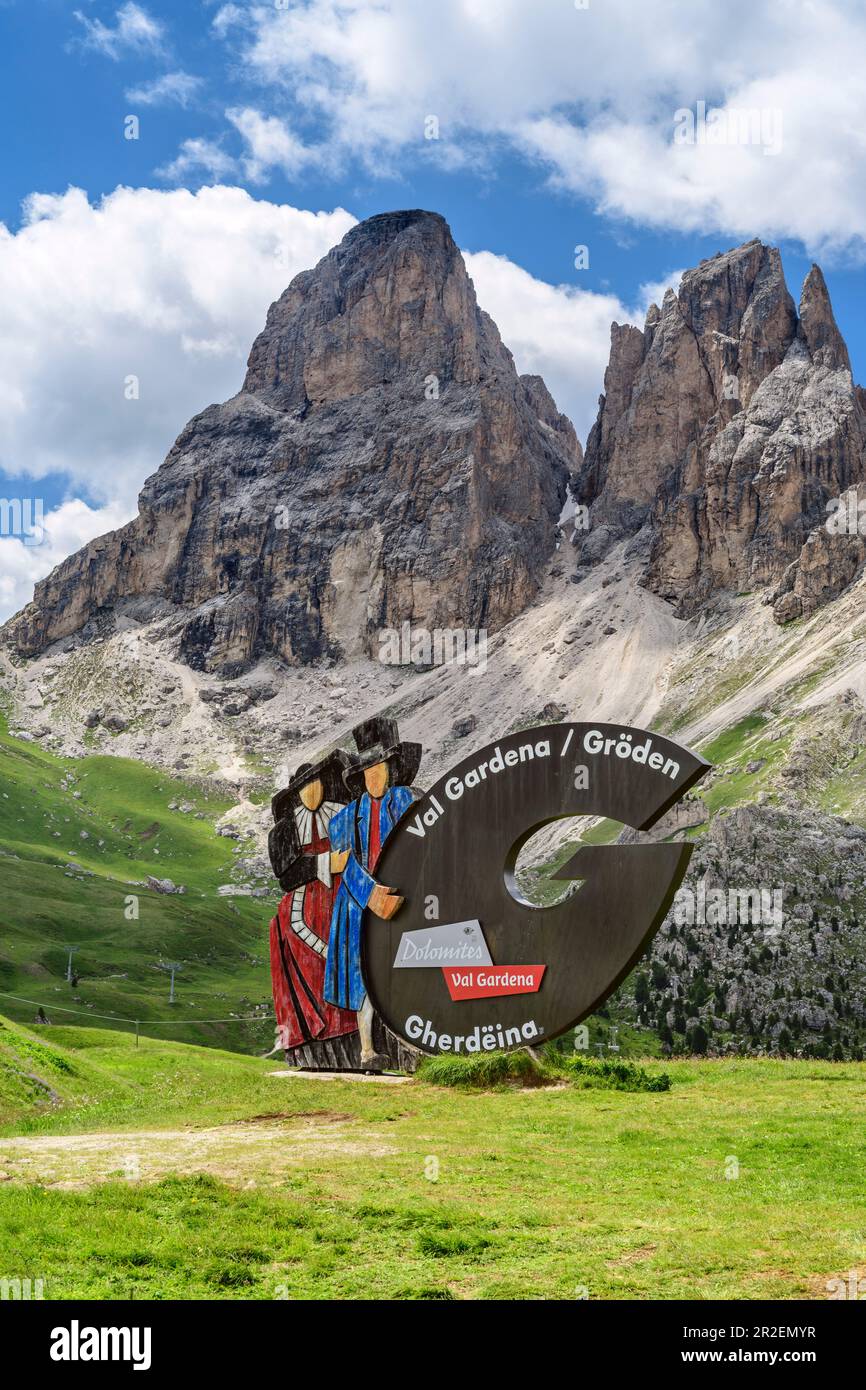 Advertising board of the Val Gardena with woman and man in traditional ...