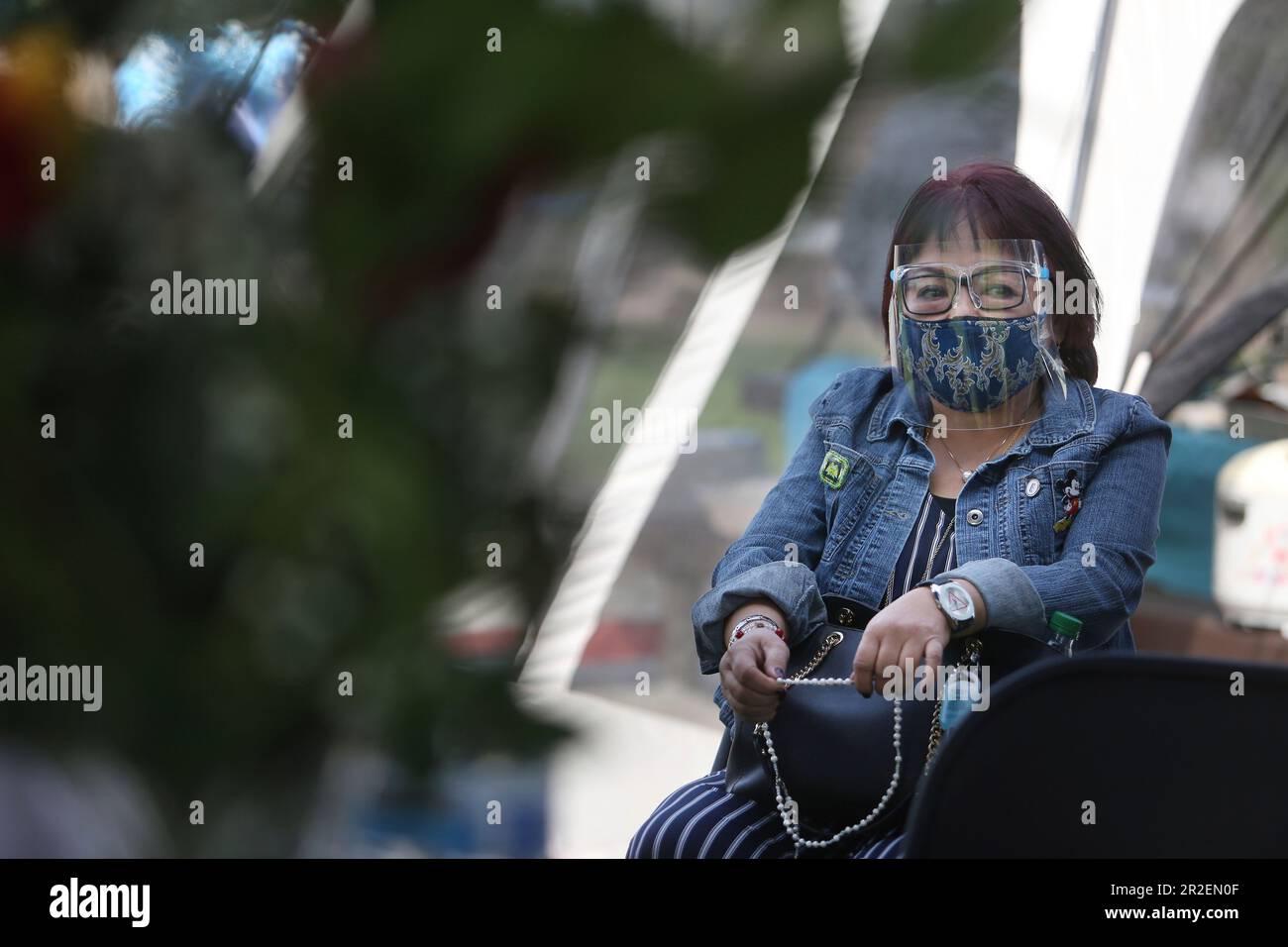 Jeannie Atienza holds her rosary and prays with other guests as she ...