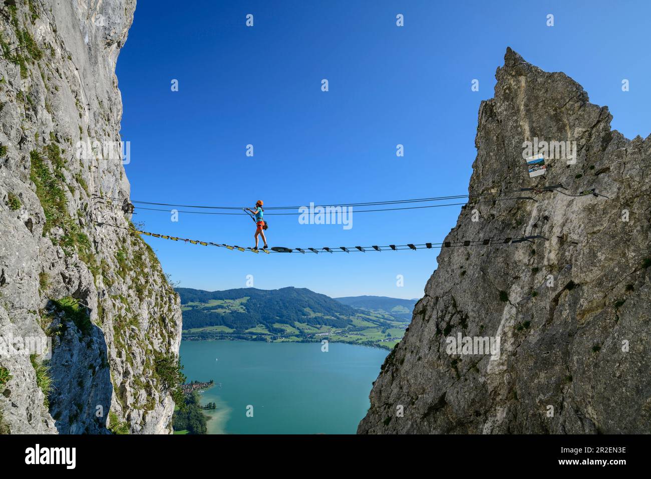 Woman walks on via ferrata over suspension bridge, via ferrata ...