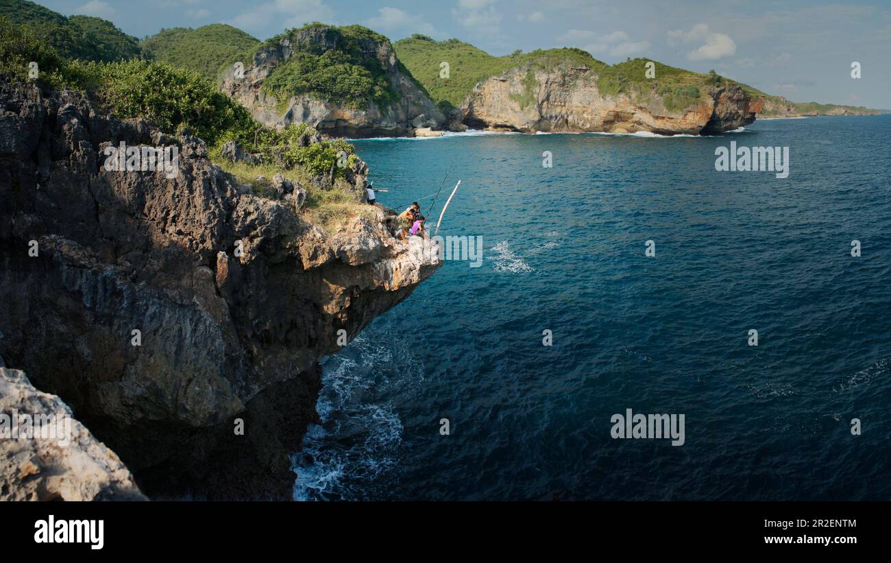 fisherman on top coastal cliff.coastal cliff landscape in summer.Indian Ocean view from karst ...