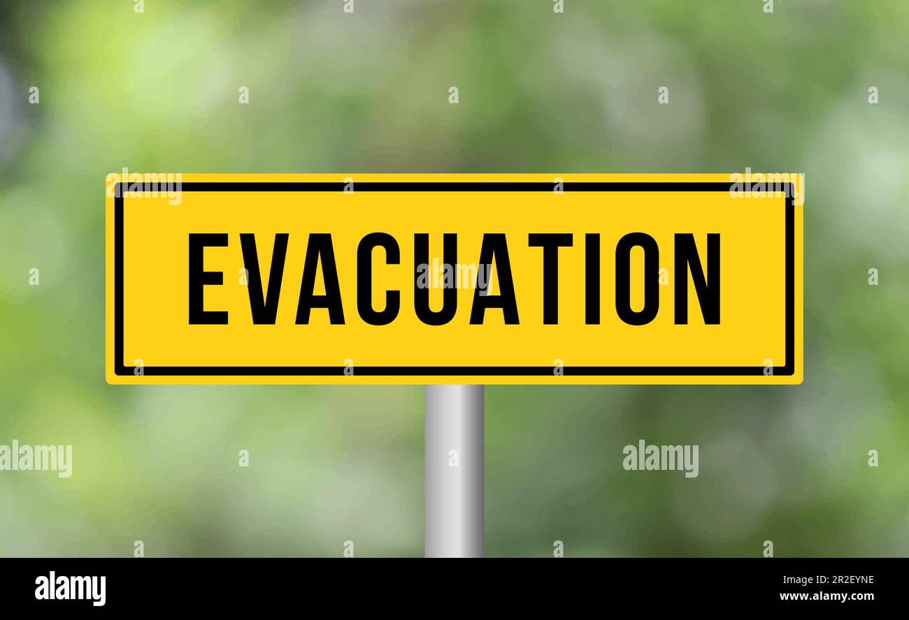 Evacuation road sign on blur background Stock Photo - Alamy
