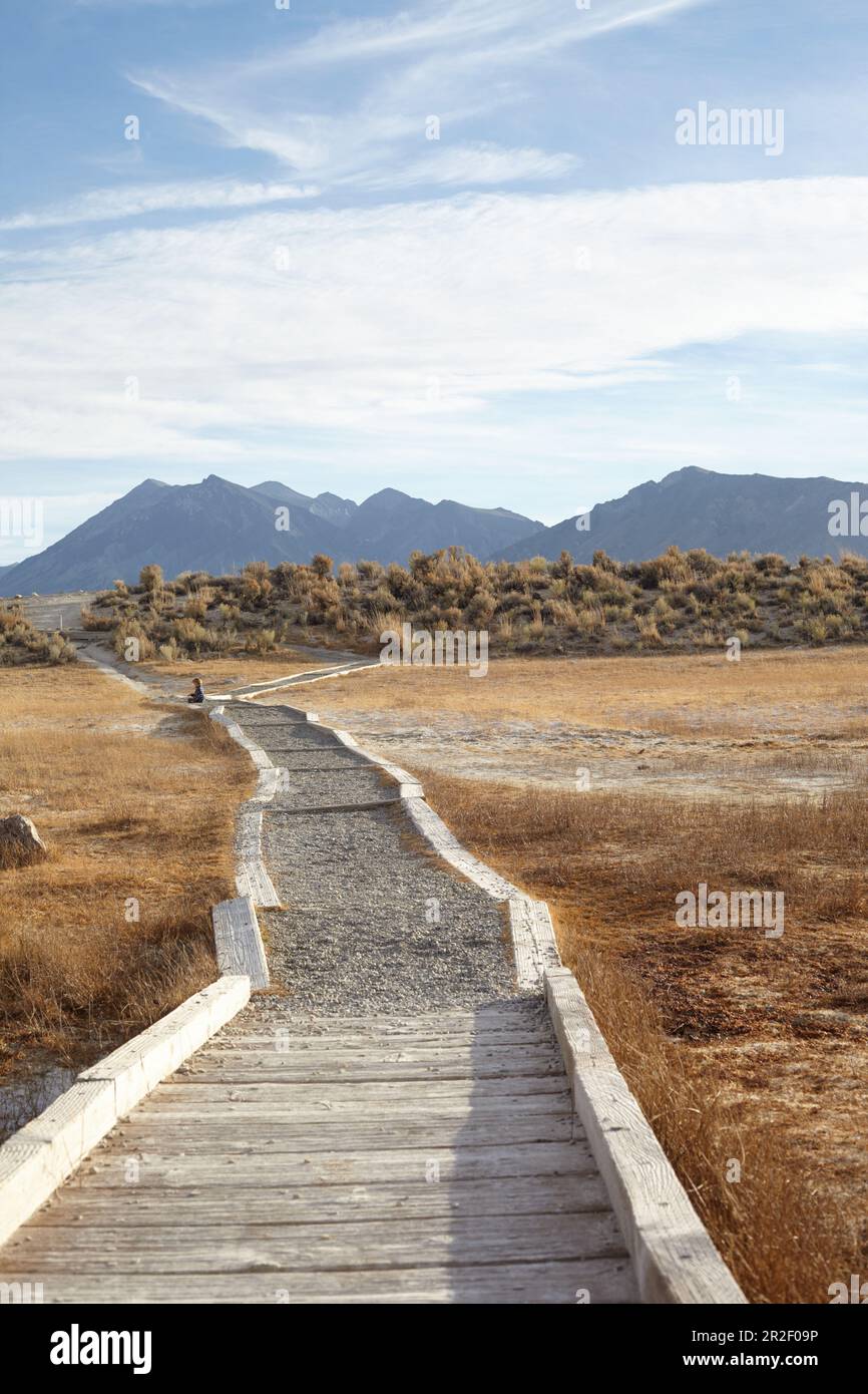 Child on a path through steppe landscape in the Eastern Sierra ...