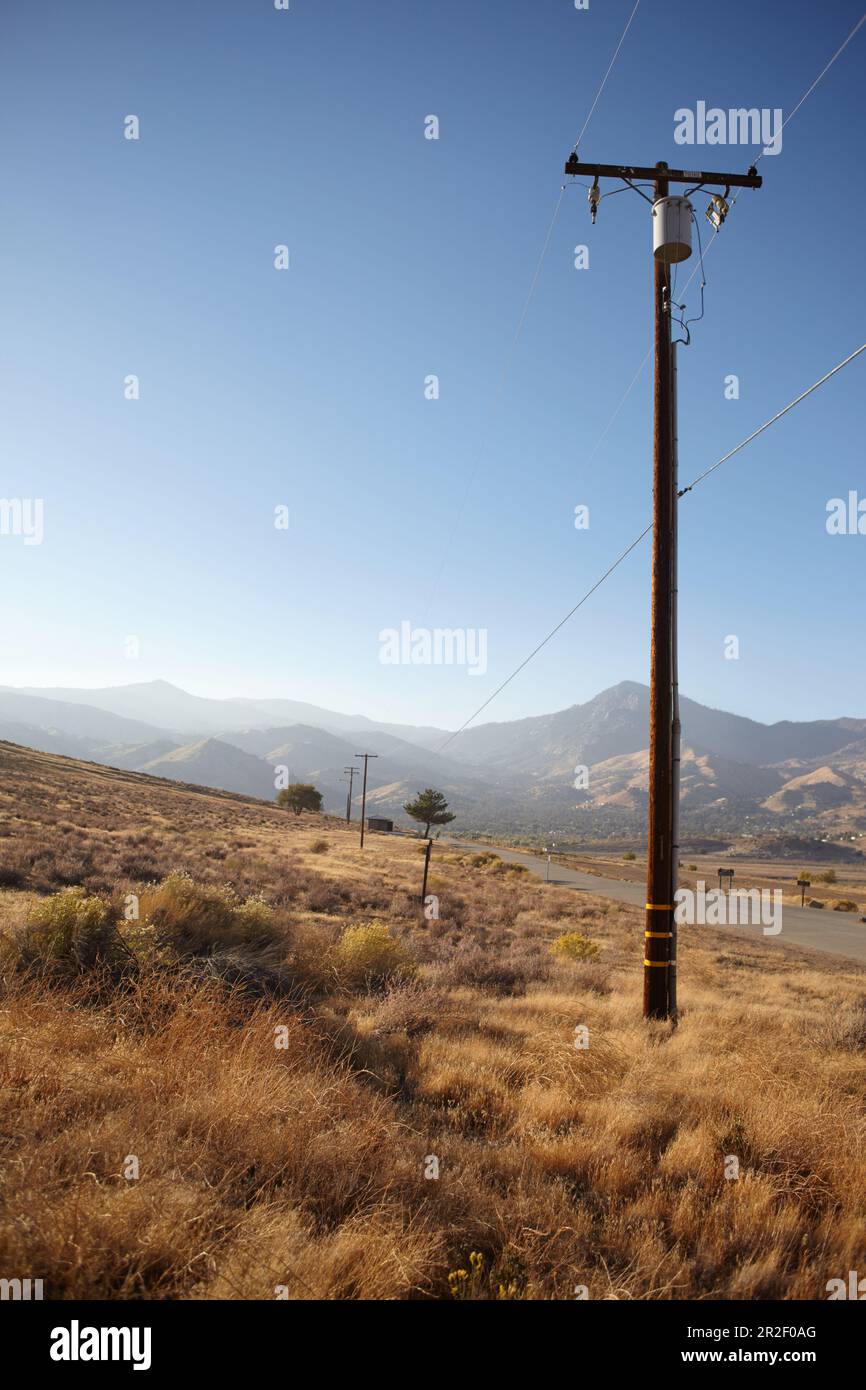 Electricity pylon on a road through reddish steppe grass. California ...