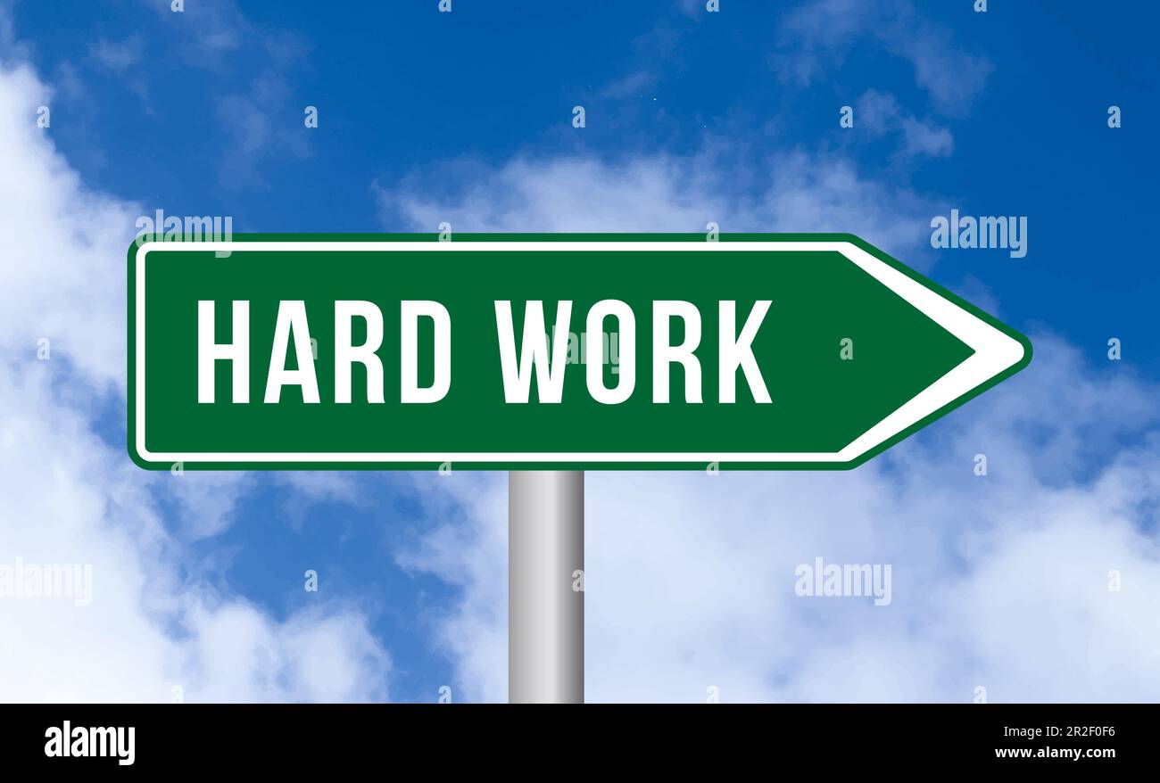 Hard work road sign on sky background Stock Photo - Alamy