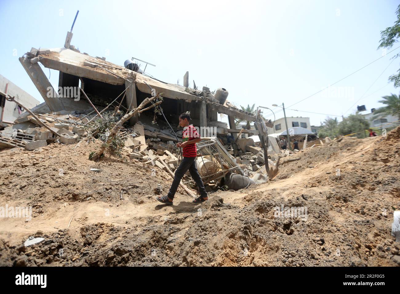 A child is seen in front of a destroyed building belonging to the Al ...