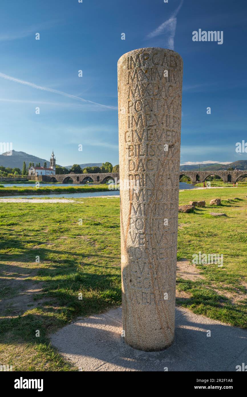 Roman memorial column at Ponte de Lima bridge with church at day ...