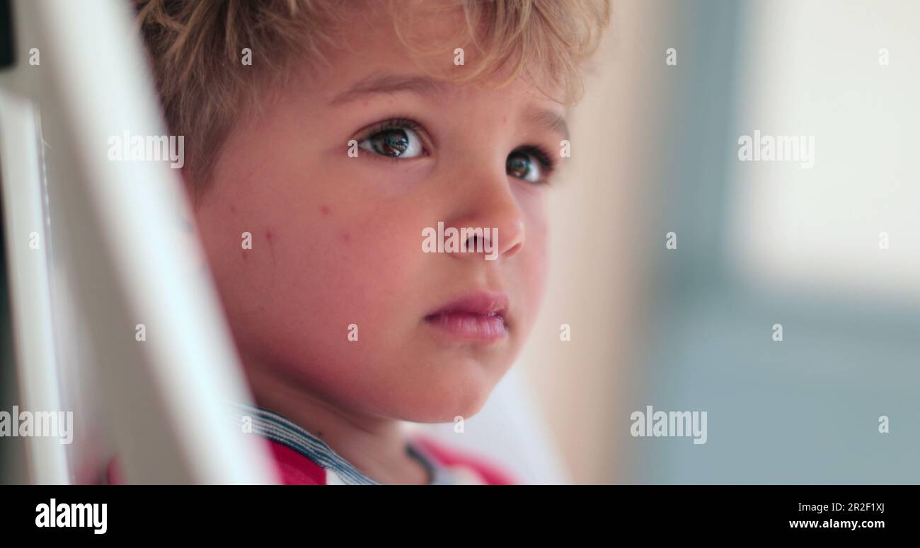 Little boy sitting down relaxing, toddler child thinking about life ...