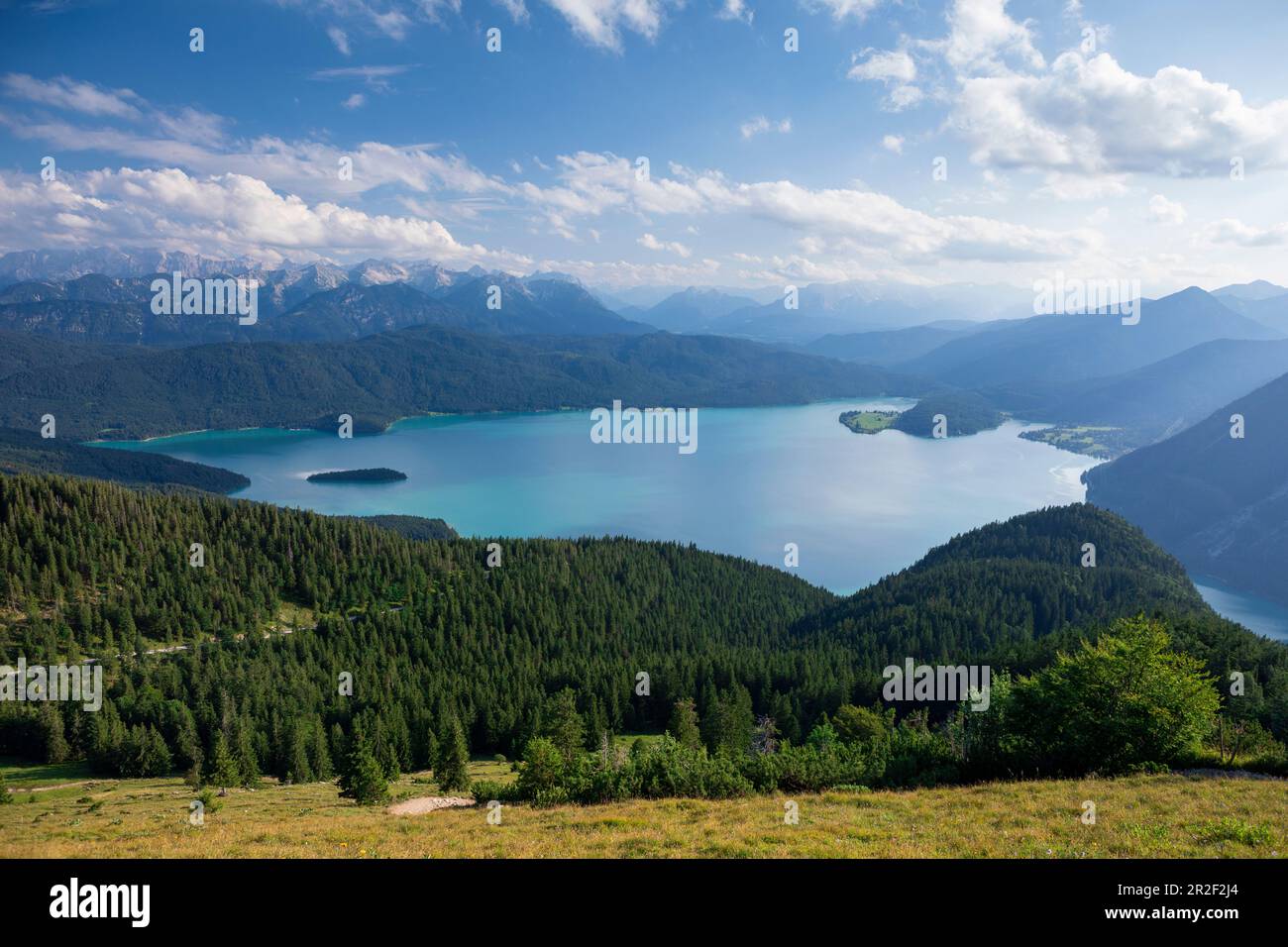 Turquoise Walchensee with Sassau island, forest, mountains and clouds ...