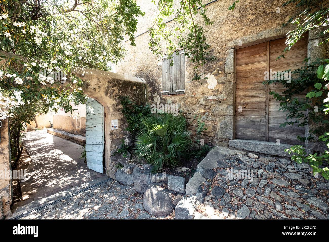 Gate entrance in the mountain village of Pigna near Calvi, Corsica ...