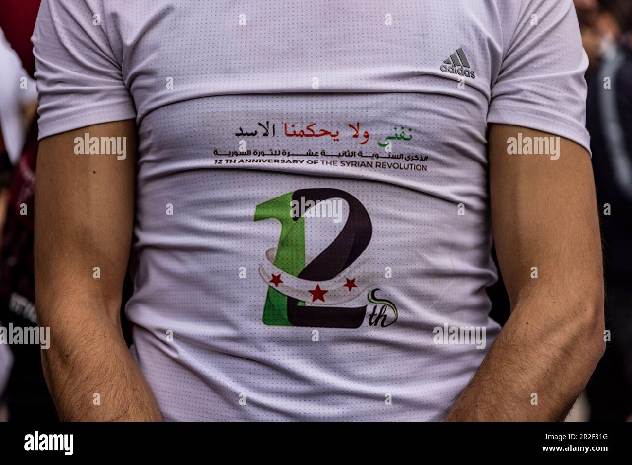 Idlib, Syria. 19th May, 2023. A Syrian wearing a t-shirt reads "Being ...