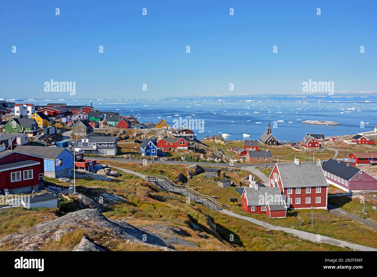 Disco bay; West Greenland; brightly painted wooden houses by Ilulissat ...
