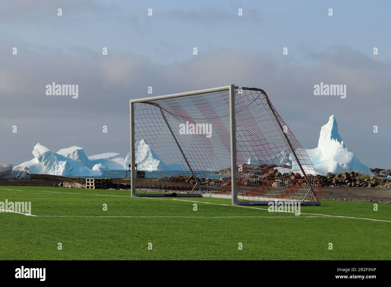 Soccer field by the sea; on the outskirts of Qeqertarsuaq; Disko Island ...