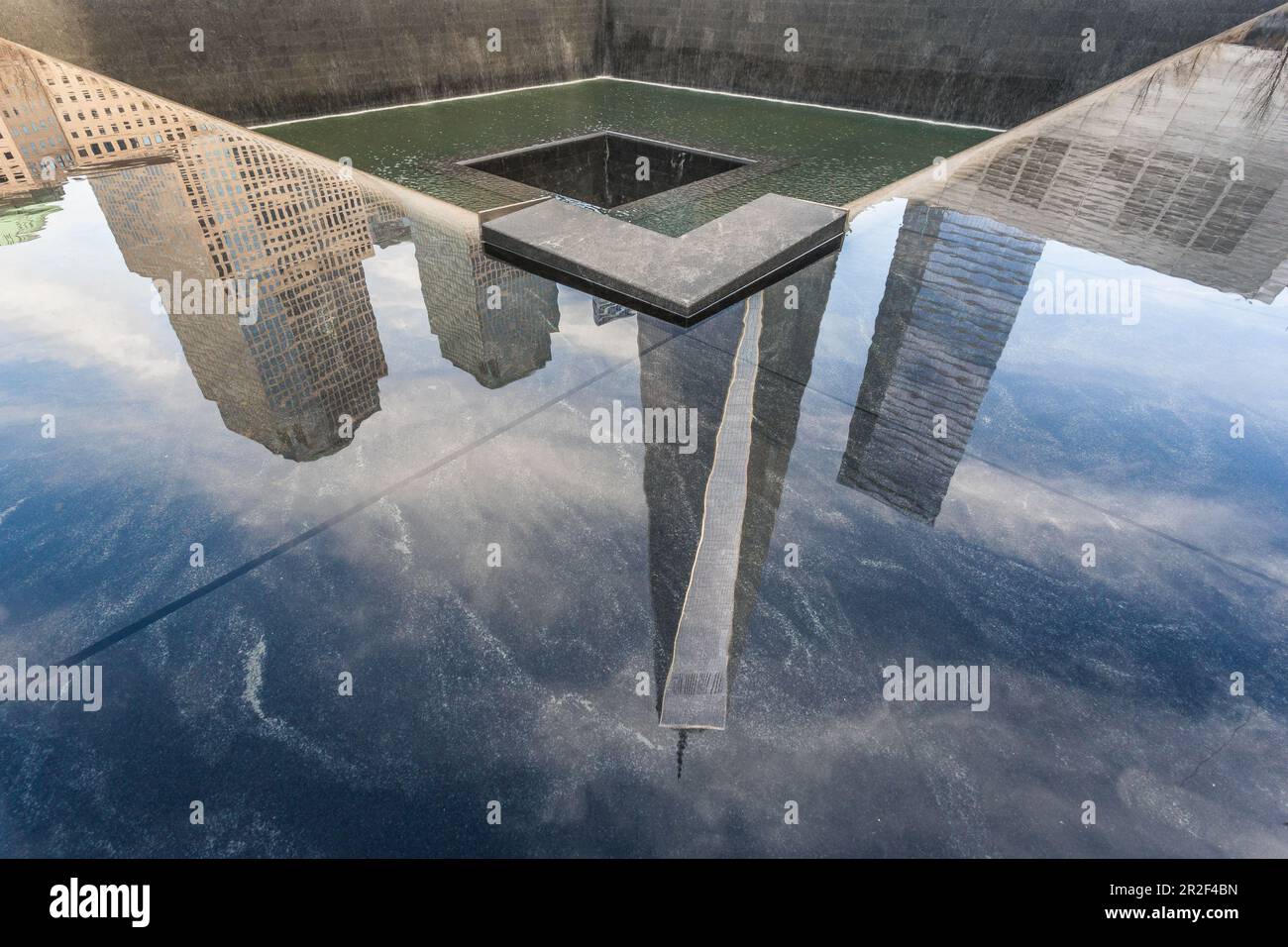 Reflection of the One World Trade Center in the 9/11 Memorial, New York ...