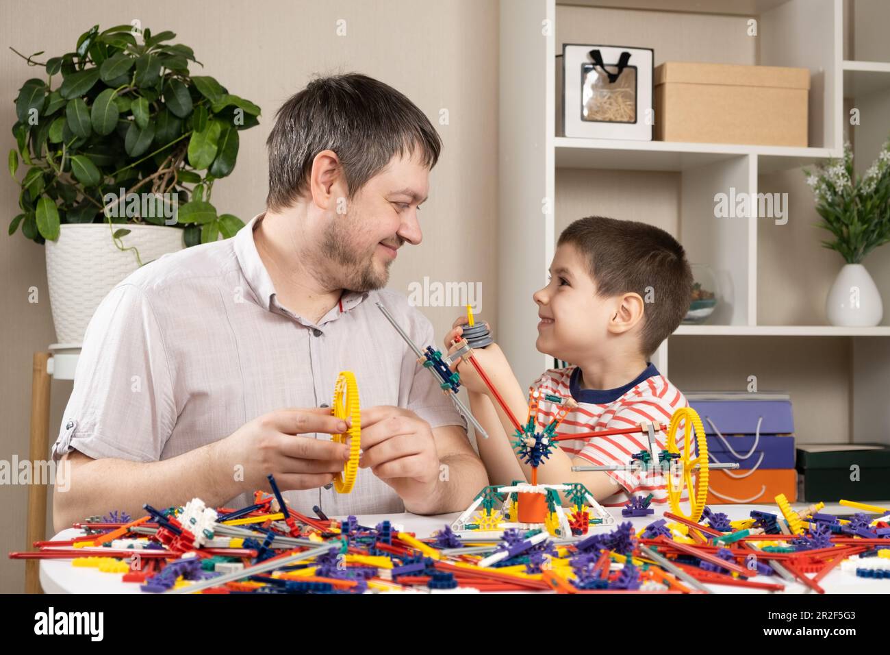 Dad and son build figures from the constructor. Spending time together ...