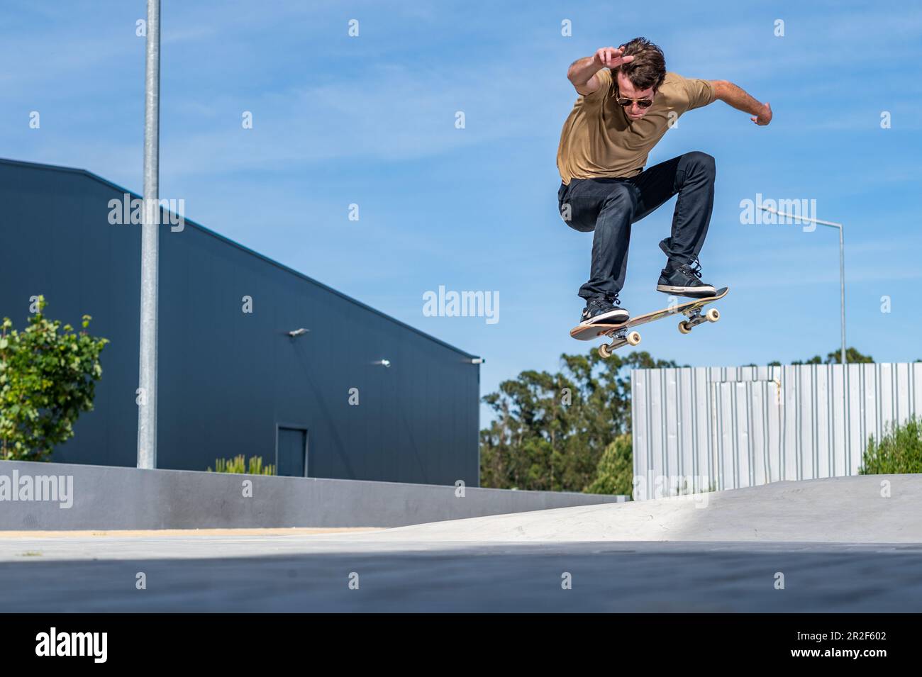 Skateboarder doing ollie trick on a urban scene Stock Photo - Alamy