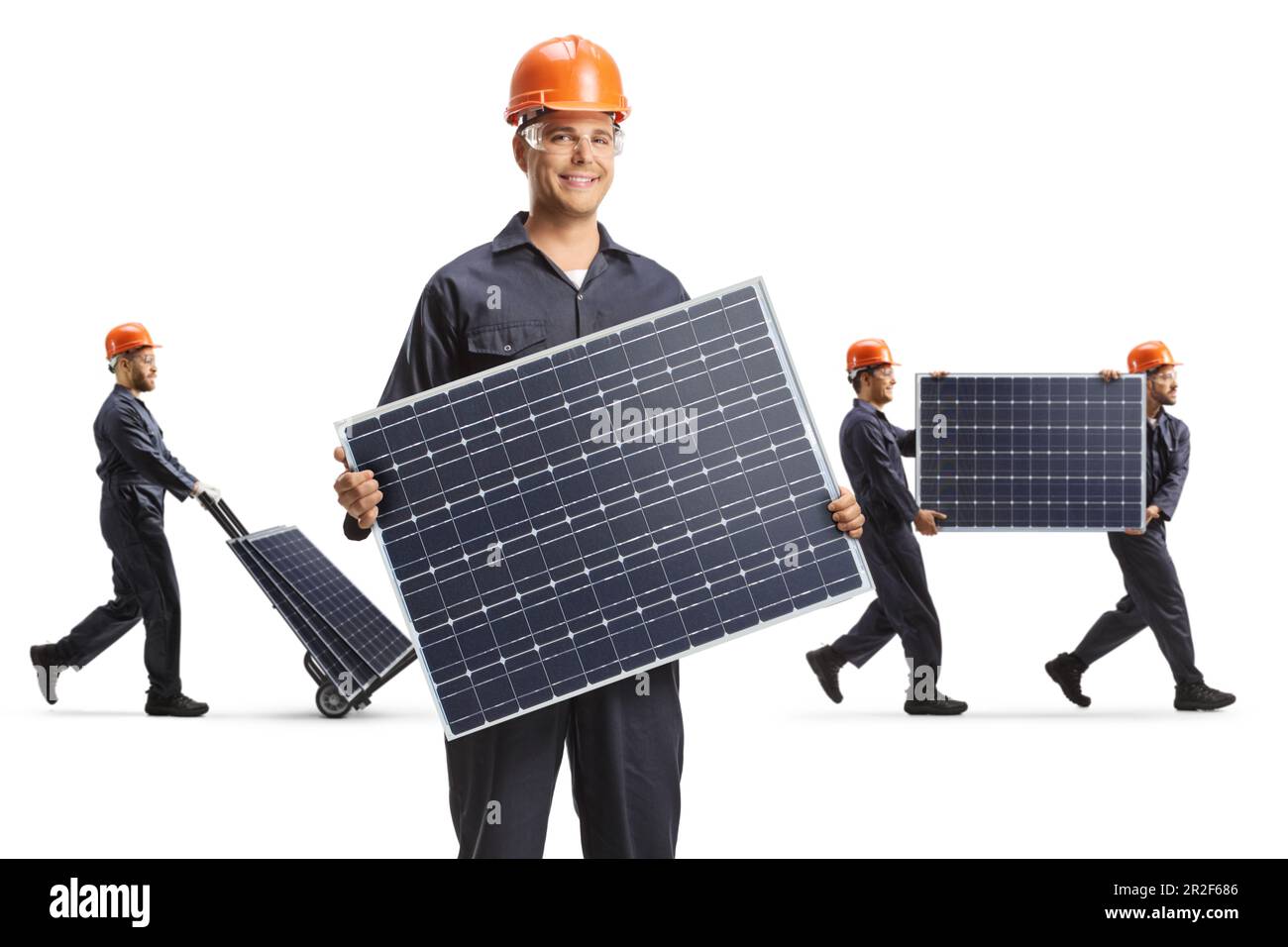 Factory worker in a uniform holding a solar panel and other workers ...