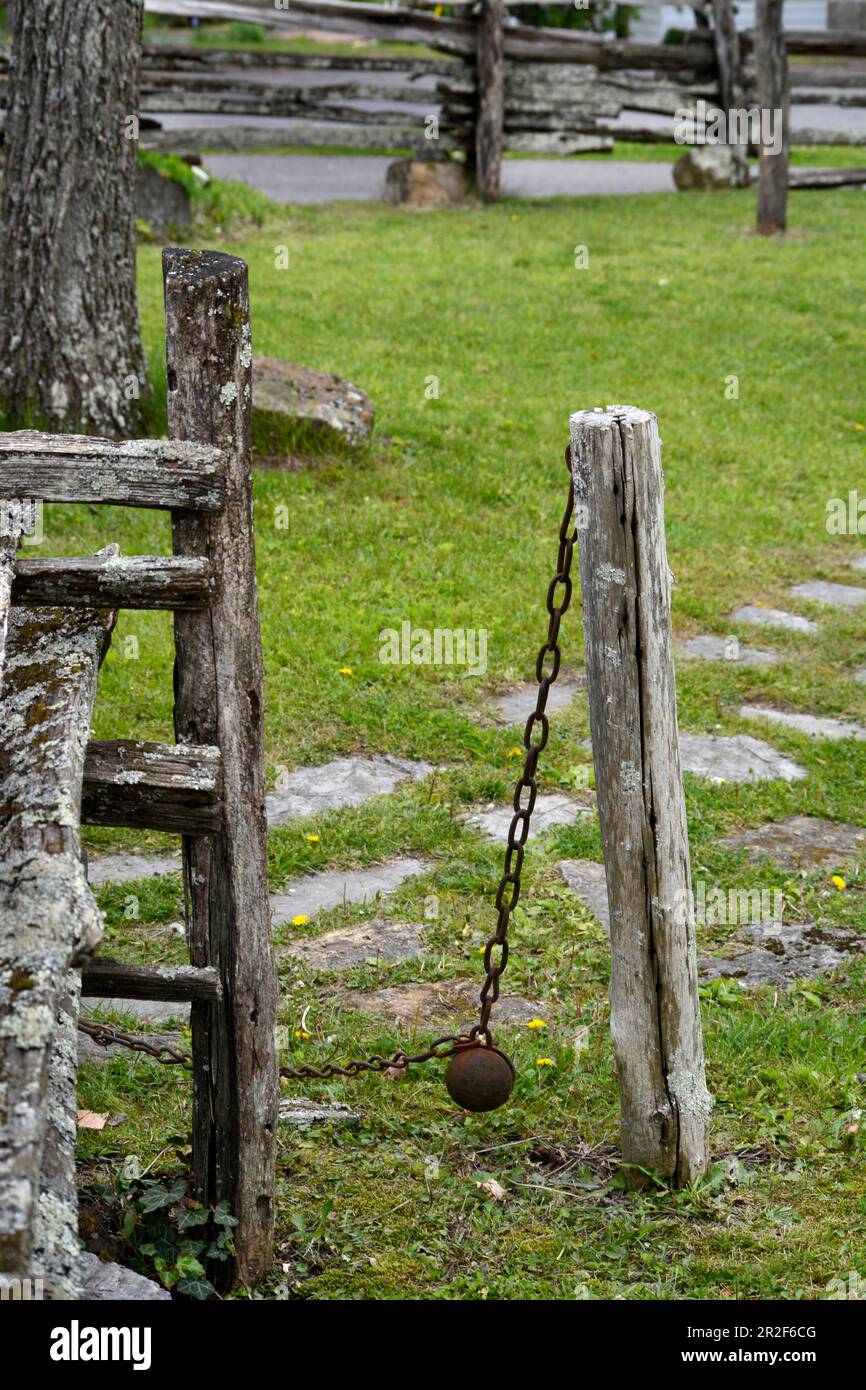 An early-American style gate which closes automatically because of an ...
