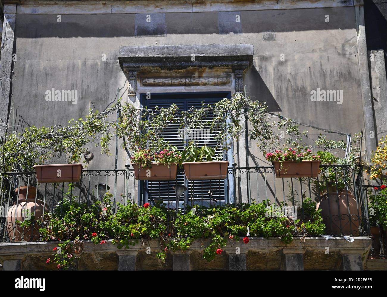 Rural house facade with a weathered wall a handcrafted wrought iron ...
