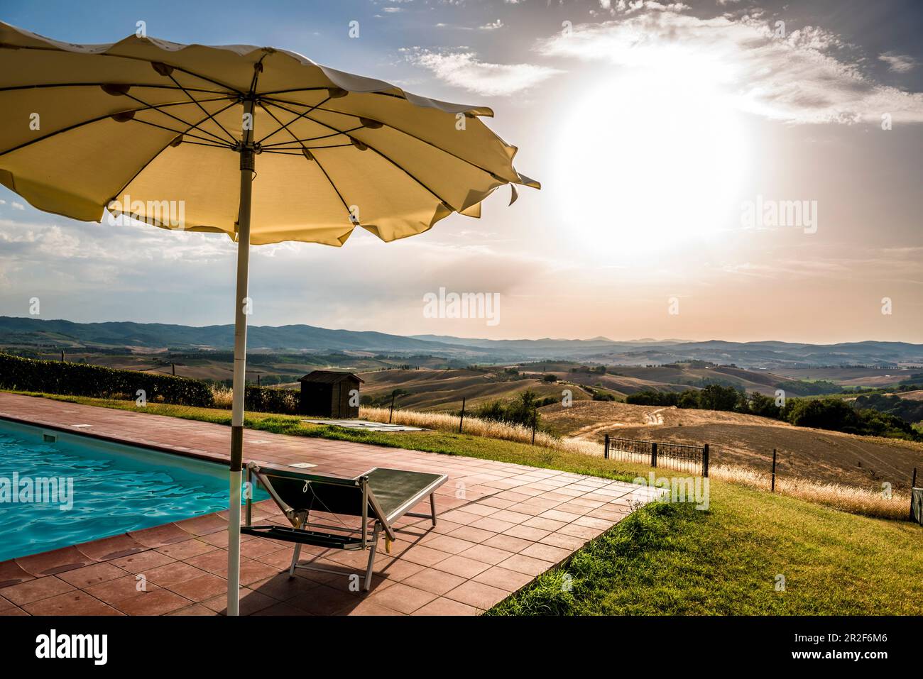 Sunbed and umbrella by a pool, Buonconvento, Tuscany, Italy Stock Photo ...