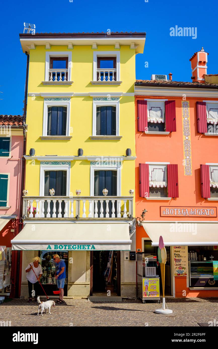 Shop and colorful house facades in Caorle, Veneto, Italy Stock Photo ...