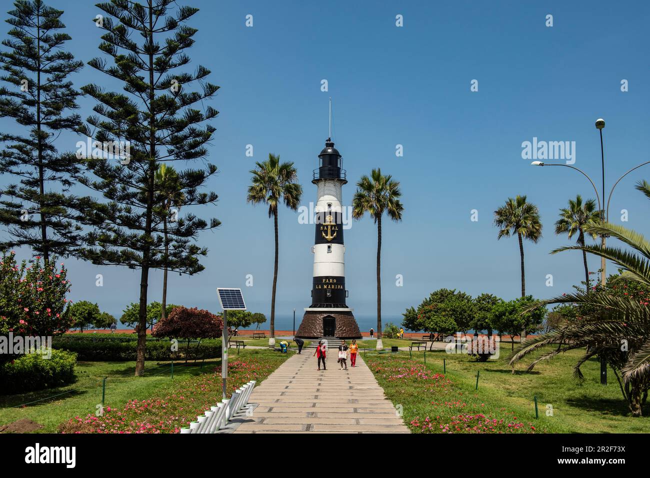 Visitors take pictures of the lighthouse of La Marina (22 m above sea ...